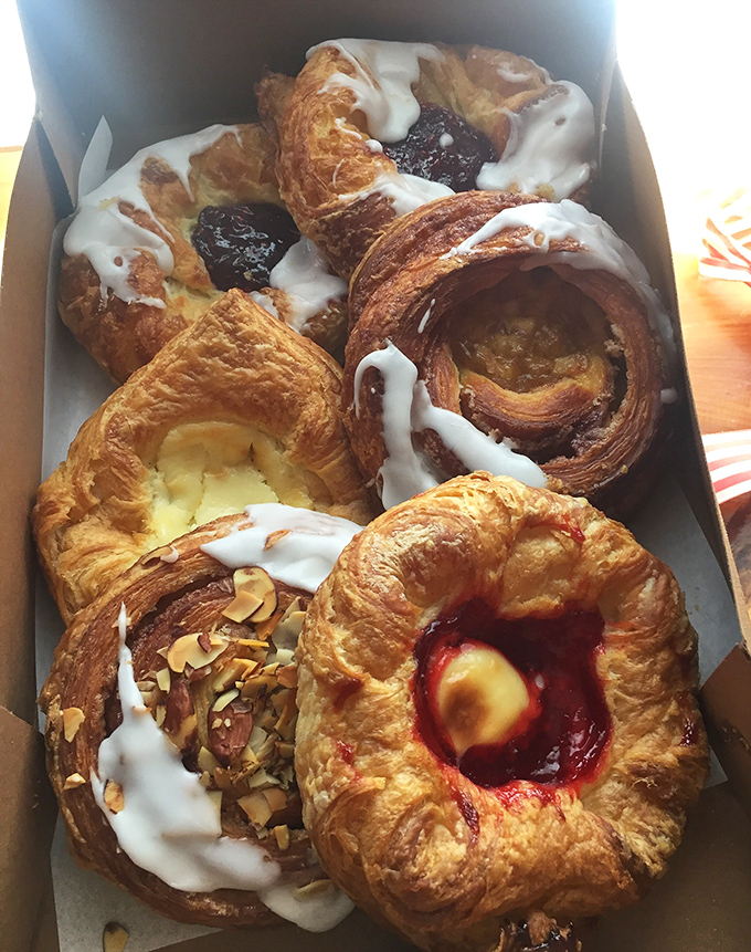 Golden treasures lined up like edible jewelry, each pastry a masterpiece waiting to be discovered.