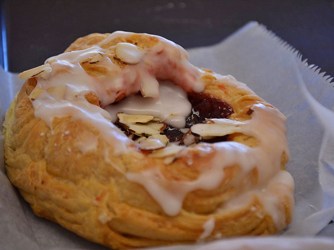 This isn't just pastry&mdash;it's edible architecture. Flaky layers cradle jam and almonds beneath a glaze so perfect it belongs in an art gallery.