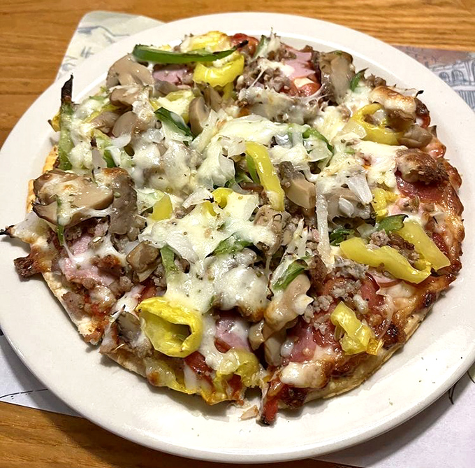 A symphony of toppings performing in perfect harmony on a crispy stage. Those banana peppers add the high notes that make this pizza sing.