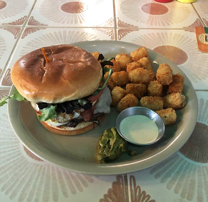 This isn't just a burger&mdash;it's architecture. The perfectly stacked creation comes with crispy tots and a side of "where have you been all my life?"
