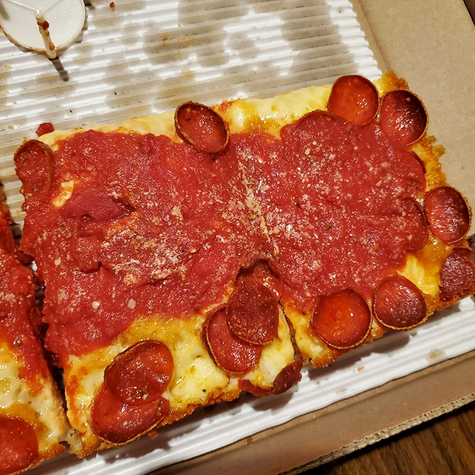 The pepperoni cups forming little flavor pools are not accidents&mdash;they're divine intervention. This Detroit-style slice makes round pizza seem like a missed opportunity.