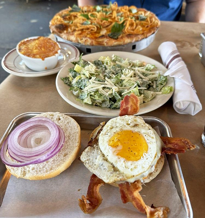 Breakfast meets burger in this magnificent morning mashup. That sunny-side egg isn't just looking at you&mdash;it's winking, promising a perfect yolk cascade with every bite.