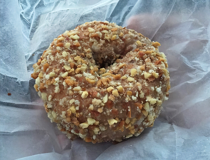 Not all heroes wear capes—some come covered in crunchy nut topping. This donut doesn't need Instagram filters to look irresistible.
