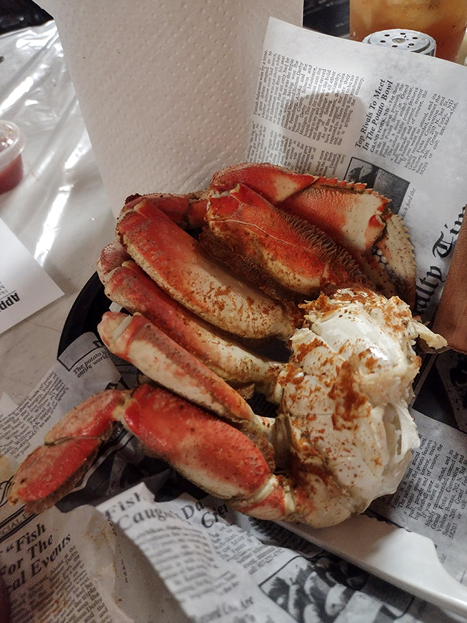 Snow crab clusters served on newspaper – nature's perfect design meets no-nonsense presentation. Seafood this fresh needs no fancy plate.