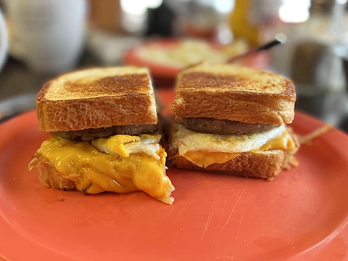 Behold the star attraction: golden-toasted bread embracing melty cheese, perfectly cooked eggs, and savory meat &ndash; breakfast architecture at its finest. 