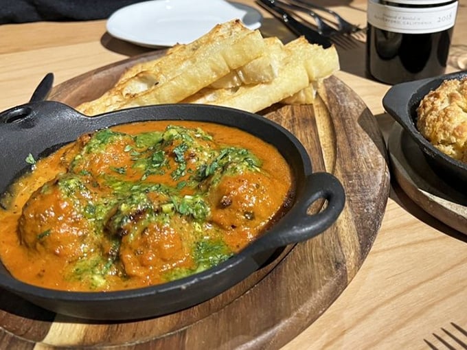 These eggplant meatballs swim in marinara like tiny flavor submarines, ready to torpedo your preconceptions about vegetarian food.