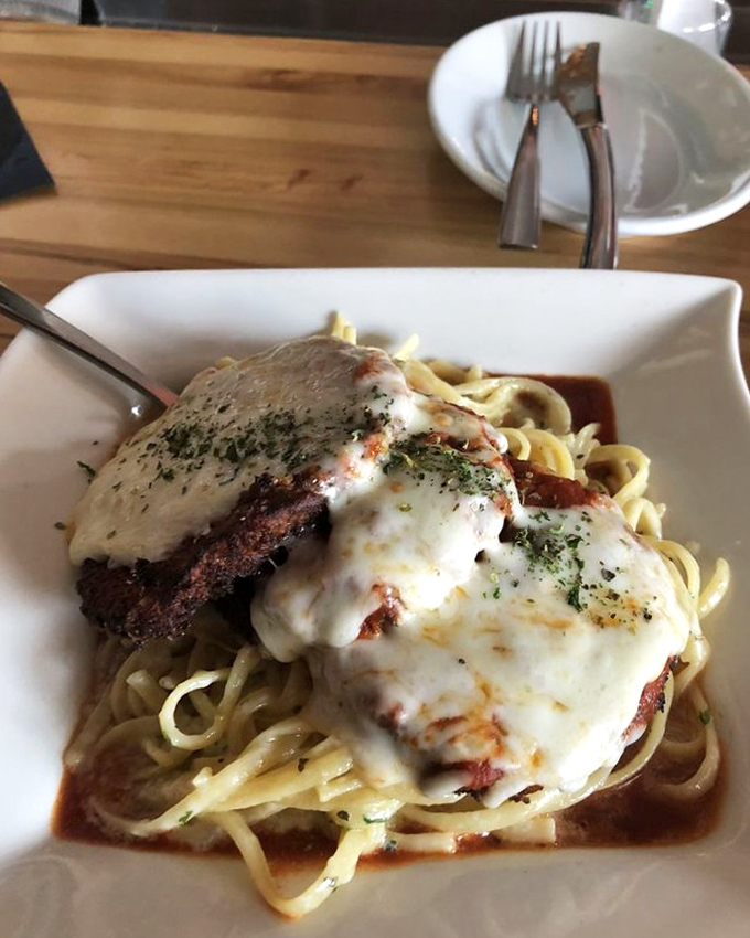 This isn't your nonna's eggplant parm&mdash;it's a melty masterpiece of crispy-meets-creamy, perched atop pasta like it owns the place.
