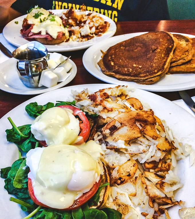 Behold the eggs Benedict in all its glory&mdash;perfectly poached eggs nestled on spinach and tomato, draped in hollandaise that cascades like a golden waterfall.