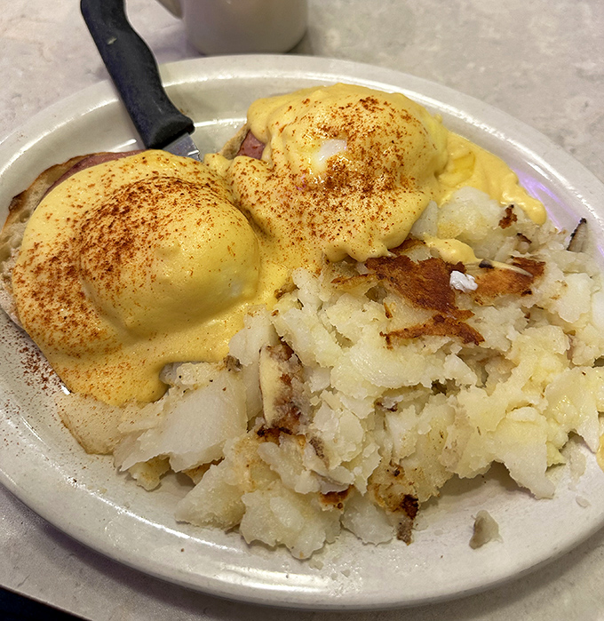 Eggs Benedict: where hollandaise dreams come true. Those crispy home fries aren't just a side dish—they're the supporting actor deserving their own Oscar.
