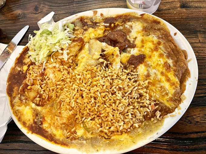This isn't just dinner—it's an edible work of art. Enchiladas smothered in sauce and cheese, with perfectly seasoned rice that refuses to be an afterthought.