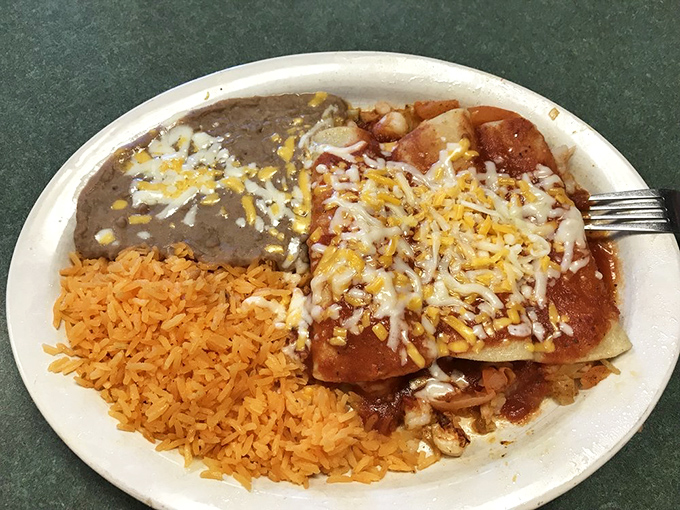 Enchilada perfection on a plate. The holy trinity of handmade tortillas, slow-simmered sauce, and perfectly seasoned filling creates a dish worth building road trips around.