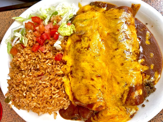 Cheese-blanketed enchiladas swimming in that legendary sauce – this isn't just dinner, it's edible therapy for your soul.