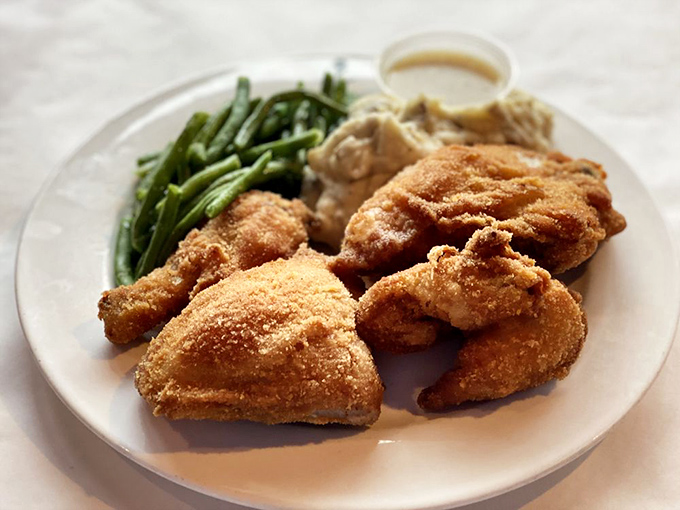 Golden-brown perfection that makes you understand why people drive for hours just for chicken. The green beans are just there for moral support.