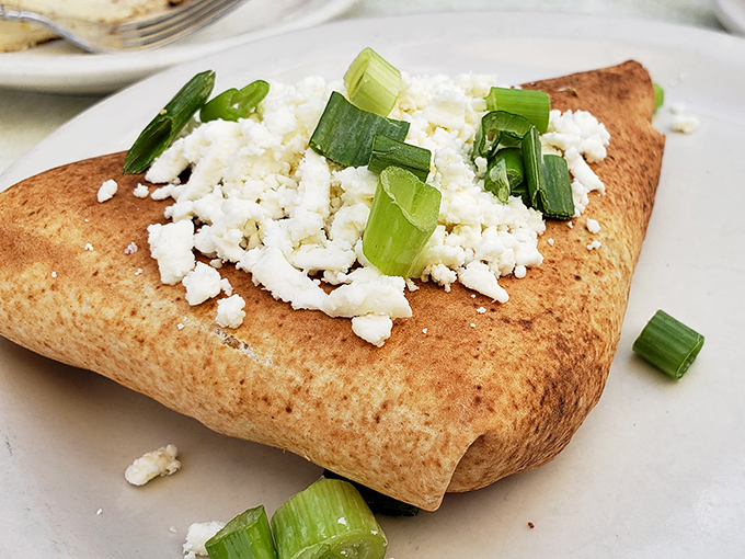 This isn't just a savory pastry &ndash; it's a Mediterranean vacation wrapped in dough, topped with feta and green onions.