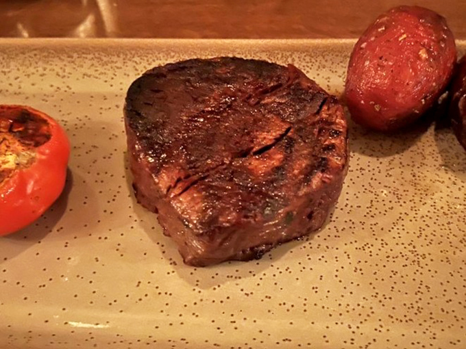 Behold the star of the show—a perfectly seared filet mignon with a crust that should win architectural awards for structural perfection.