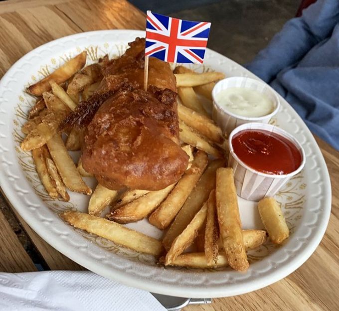 This isn't just fish and chips; it's a golden-battered masterpiece crowned with a Union Jack, declaring its allegiance to authentic British flavor.