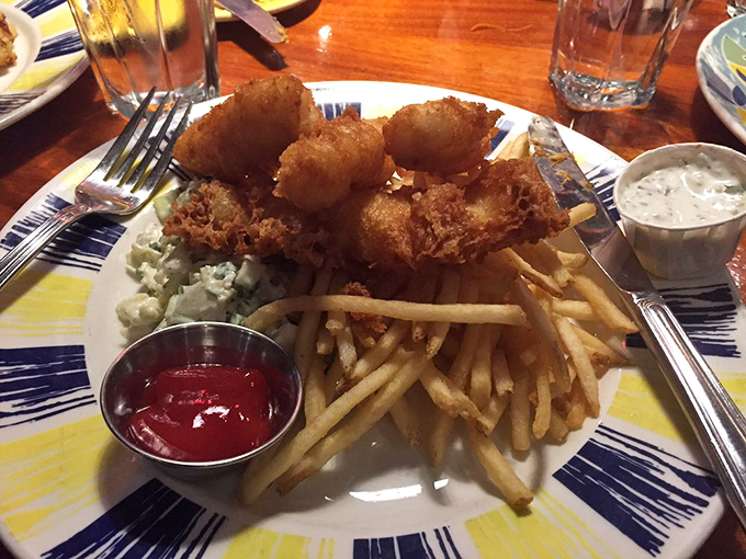 Golden-battered fish that shatters with each bite, paired with fries so perfect they deserve their own fan club.