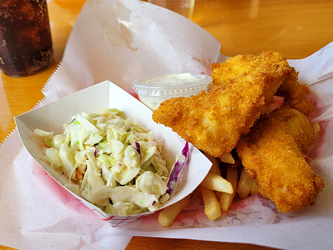 Golden-battered perfection alongside creamy coleslaw. This isn't just fish and chips&mdash;it's edible sunshine that crunches.