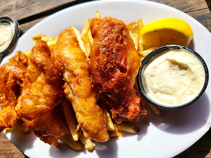 Golden-battered fish that shatters like delicate glass, revealing pearly white flesh beneath. The kind of dish that makes you temporarily forget your own name.