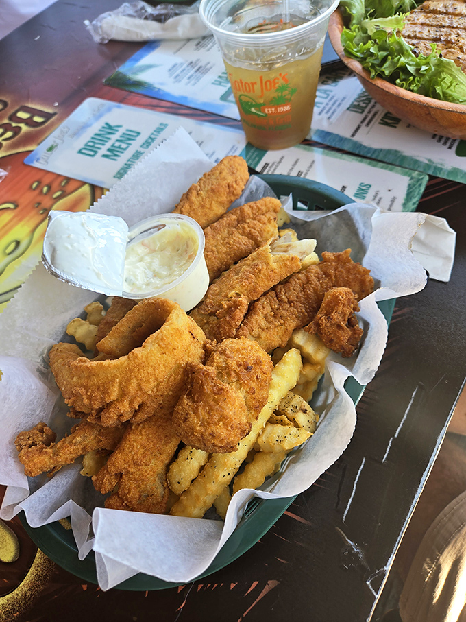 Golden-battered fish nestled among crispy fries—this isn't just fish and chips, it's Florida's edible postcard that tastes like vacation.