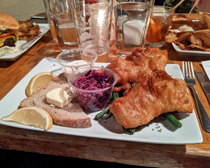 Golden-battered fish that shatters with each bite, purple slaw that pops with color, and bread that's begging to soak up every last drop of goodness.