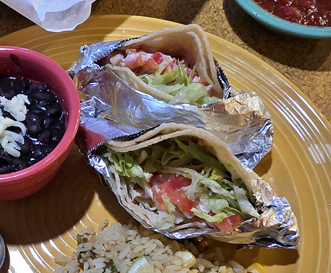 Tacos that deserve their own passport. Wrapped in foil like precious cargo, these simple beauties come with black beans that might change your life.
