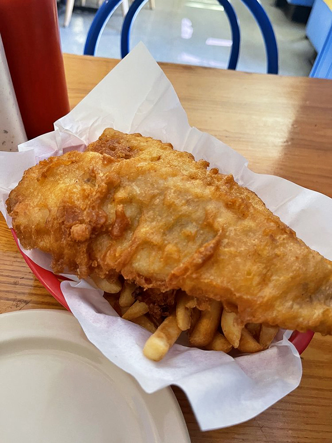 Behold the golden standard: perfectly battered fish with crispy chips that'll make your taste buds sing.