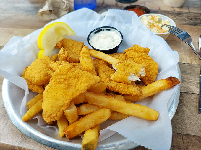 Golden-fried fish that shatters at first bite, paired with crispy fries—proof that sometimes the simplest pleasures are the most profound.