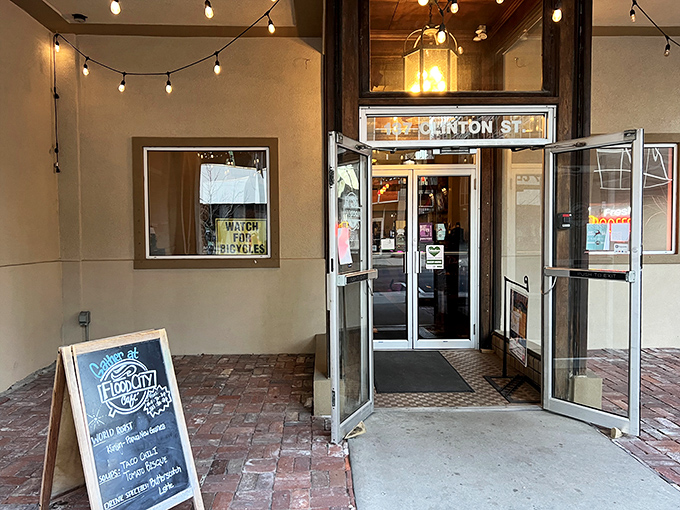 The entrance to Flood City Caf&eacute; beckons with the promise of caffeine and community. String lights and brick walkways&mdash;the universal language of "come in, stay awhile."
