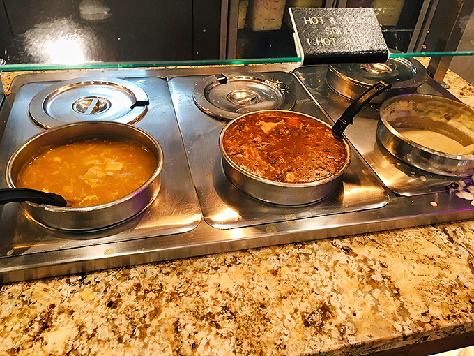 Liquid gold in those steam trays! The legendary clam chowder sits proudly alongside other soups, but we all know who the real star is.