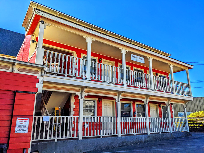 The vibrant red Francis Creek Inn beckons with wrap-around porches perfect for people-watching while sipping your morning coffee.