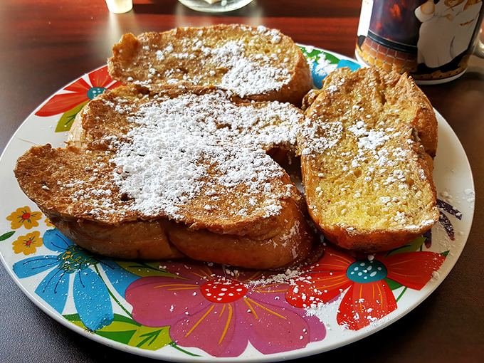 Behold the French toast that launched a thousand breakfast pilgrimages &ndash; powdered sugar falling like delicious snow.