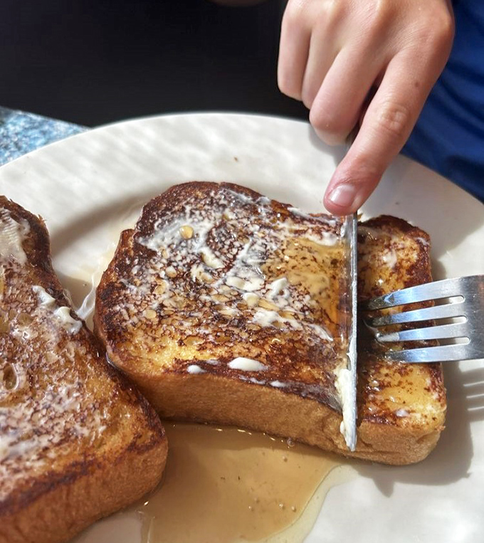 Golden-brown perfection that makes you understand why people cross county lines for breakfast. This French toast doesn't need Instagram filters—it's naturally photogenic.