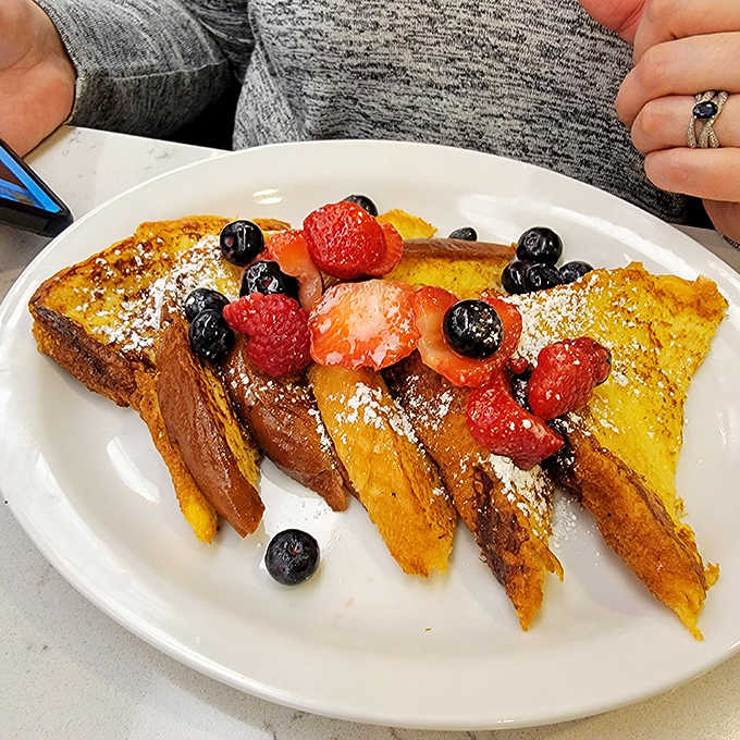 This berry-topped French toast isn't just breakfast&mdash;it's edible sunshine that transforms ordinary bread into a custard-centered miracle worth the drive.