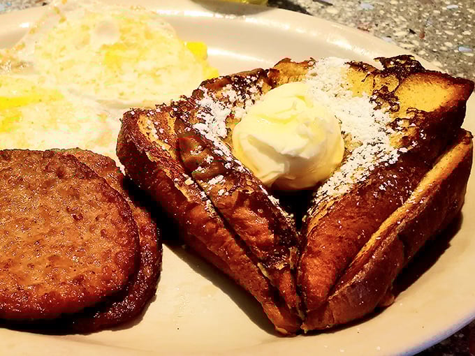 The star of the show: golden-brown French toast dusted with powdered sugar and topped with a melting pat of butter. Breakfast nirvana achieved.