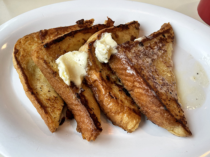 
Golden-brown French toast that's achieved the impossible dream: crispy edges with a custardy center that melts faster than your morning resolve.