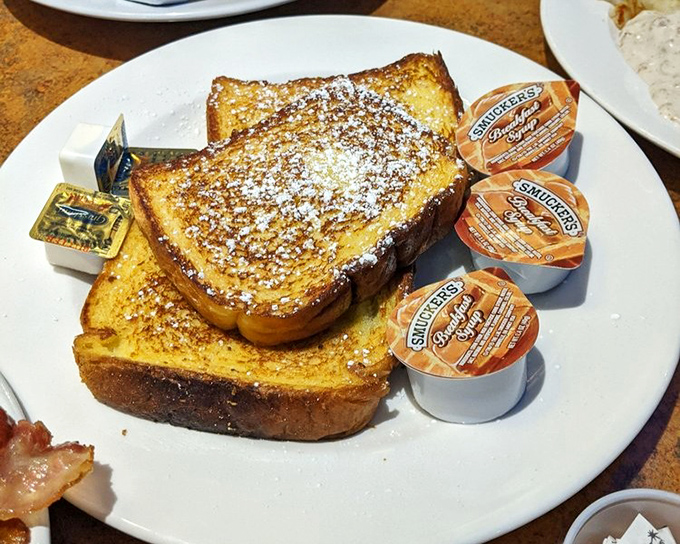 Golden-brown French toast dusted with powdered sugar&mdash;the breakfast masterpiece that launched a thousand road trips. Worth setting your alarm for.