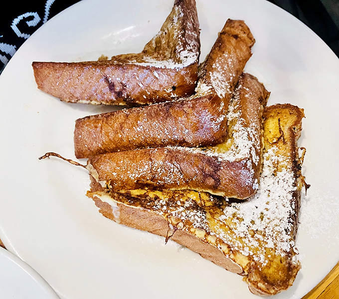 French toast stacked like golden-brown Lincoln Logs, dusted with enough powdered sugar to make angels jealous.