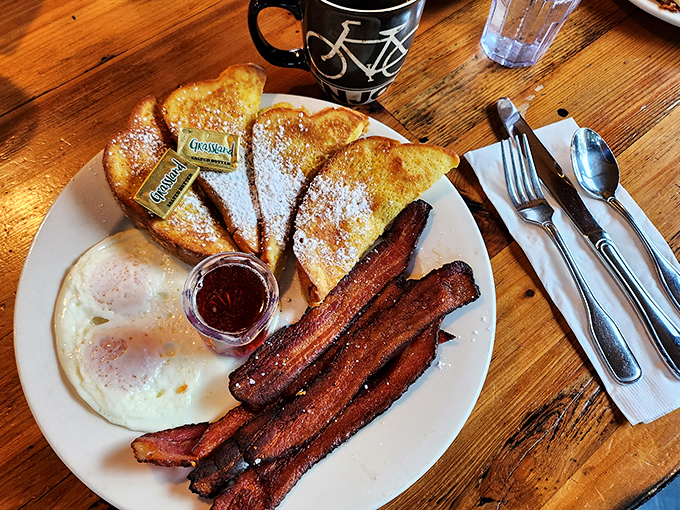 The legendary French toast in all its golden glory, dusted with powdered sugar and flanked by perfectly crisp bacon. Breakfast nirvana on a plate.