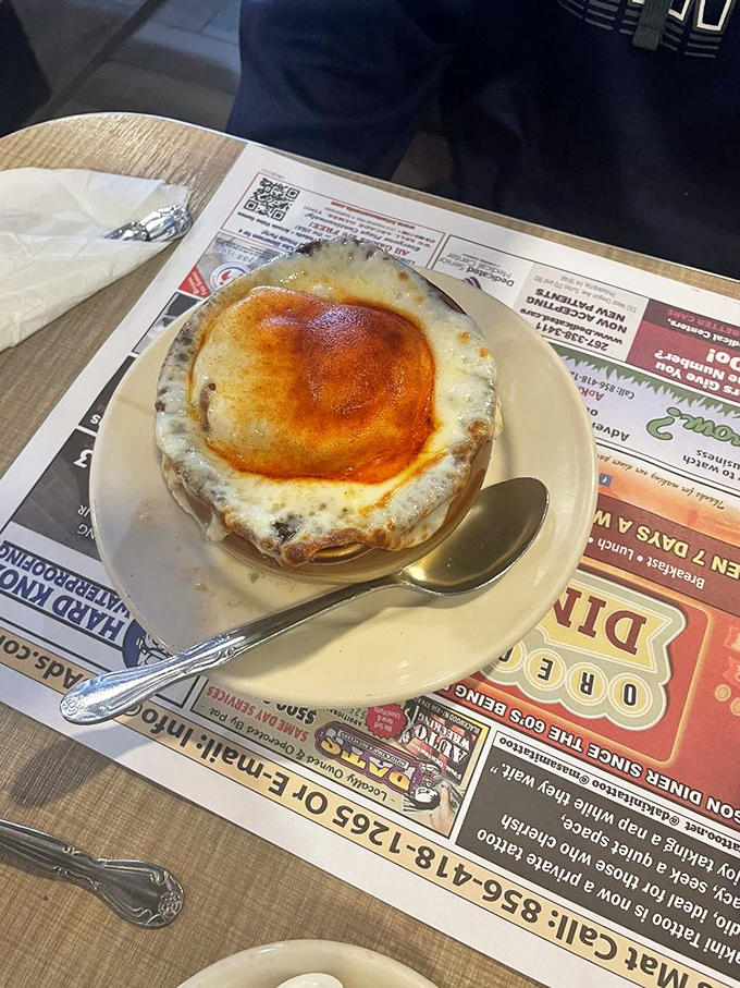Behold the French onion soup in all its glory&mdash;a bubbling cauldron of savory broth beneath a golden cheese canopy. Spoon-stretching perfection!