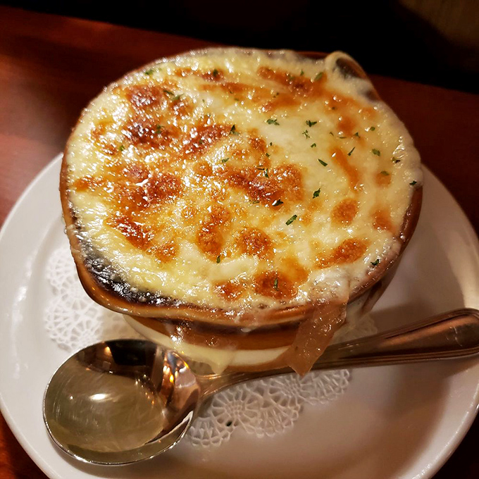 French onion soup that bubbles with promise. That golden, crusty cheese top is nature's way of saying "good things come to those who dig in."