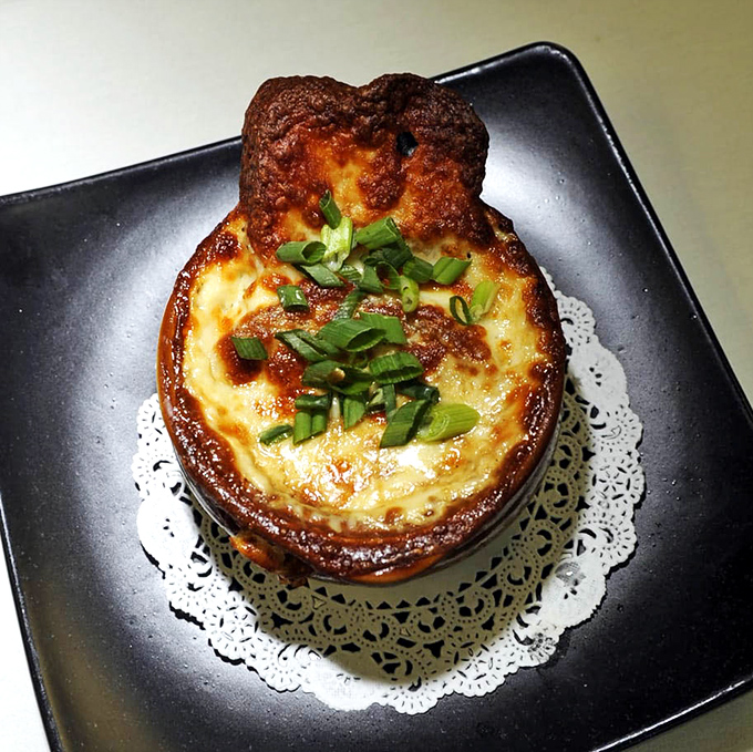 Behold the French onion soup that's worth the pilgrimage &ndash; bubbling cheese heaven in a ceramic crock.