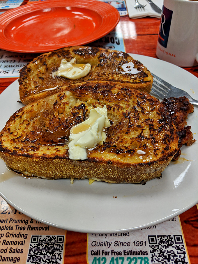 Golden-brown perfection that makes you question every other French toast you've encountered. That butter melting into those cinnamon-kissed crevices? Pure breakfast poetry.