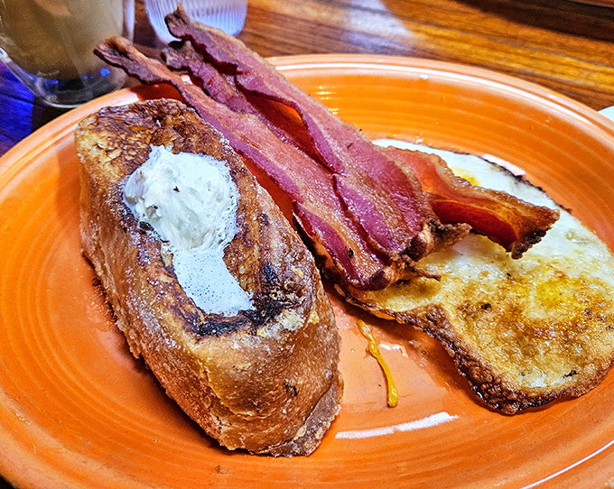 The Famous French Toast that launched a thousand return visits. Crispy exterior, custardy interior, and a dollop of butter melting into golden perfection.