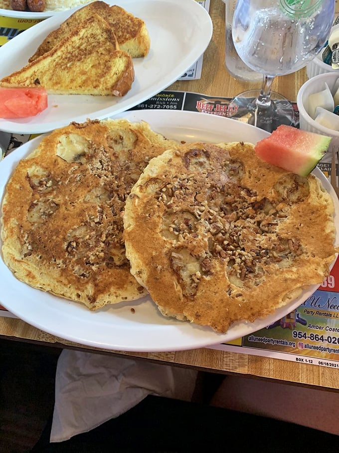Golden-brown pancakes crowned with crushed pecans &ndash; proof that sometimes the best things in life require both hands and extra napkins.