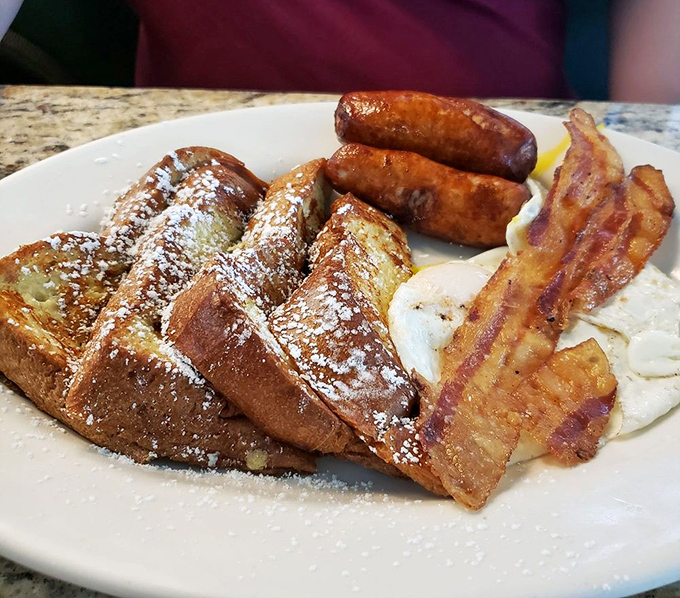 French toast that's achieved celebrity status, flanked by supporting actors of perfectly crisp bacon and sausage. Breakfast doesn't get more photogenic than this.