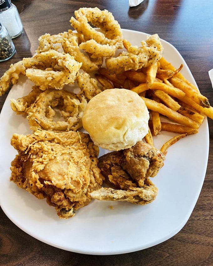 Golden-brown perfection on a plate. This isn't just fried chicken &ndash; it's edible poetry with a side of comfort and a fluffy biscuit.