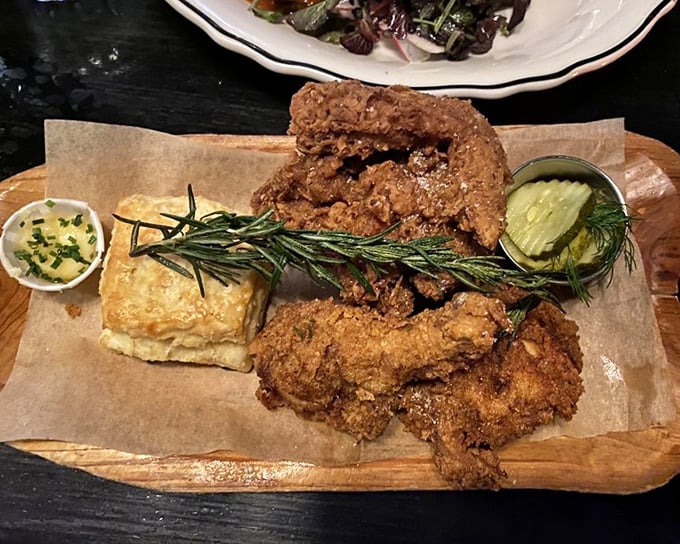 Fried chicken that makes time stand still&mdash;golden, crackling exterior giving way to juicy perfection. That rosemary sprig isn't just garnish, it's a magic wand.