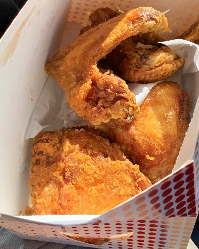 Golden-brown perfection in a box &ndash; this fried chicken doesn't need fancy plating when it's wearing a crust that crackles like a symphony.