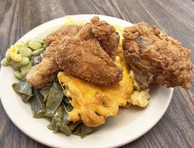 Golden-brown fried chicken perched atop mac and cheese and collards &ndash; the holy trinity of Southern comfort that makes angels sing.